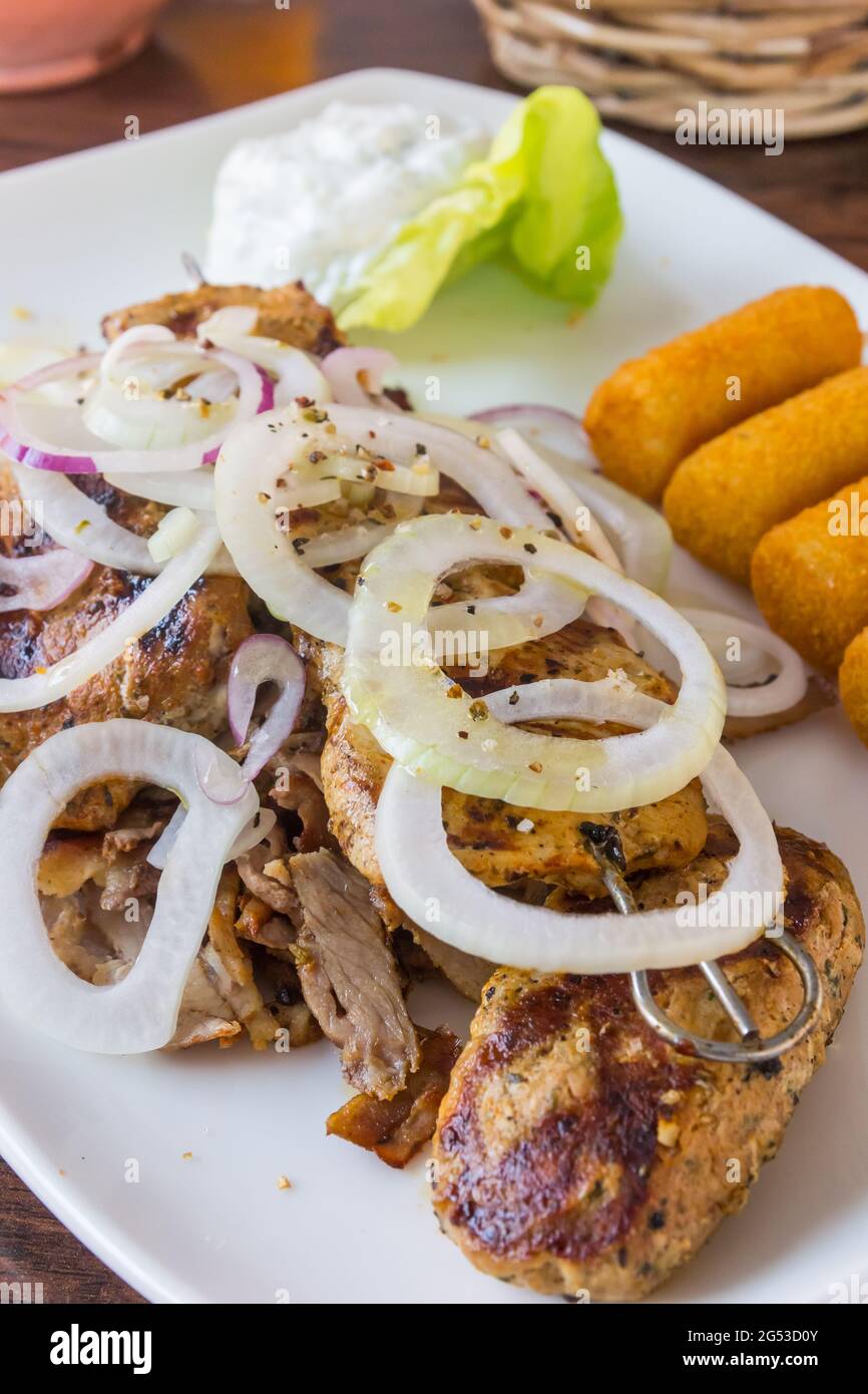 Greek meat dish in German style served with, gyros, souflaki, souzouki ...