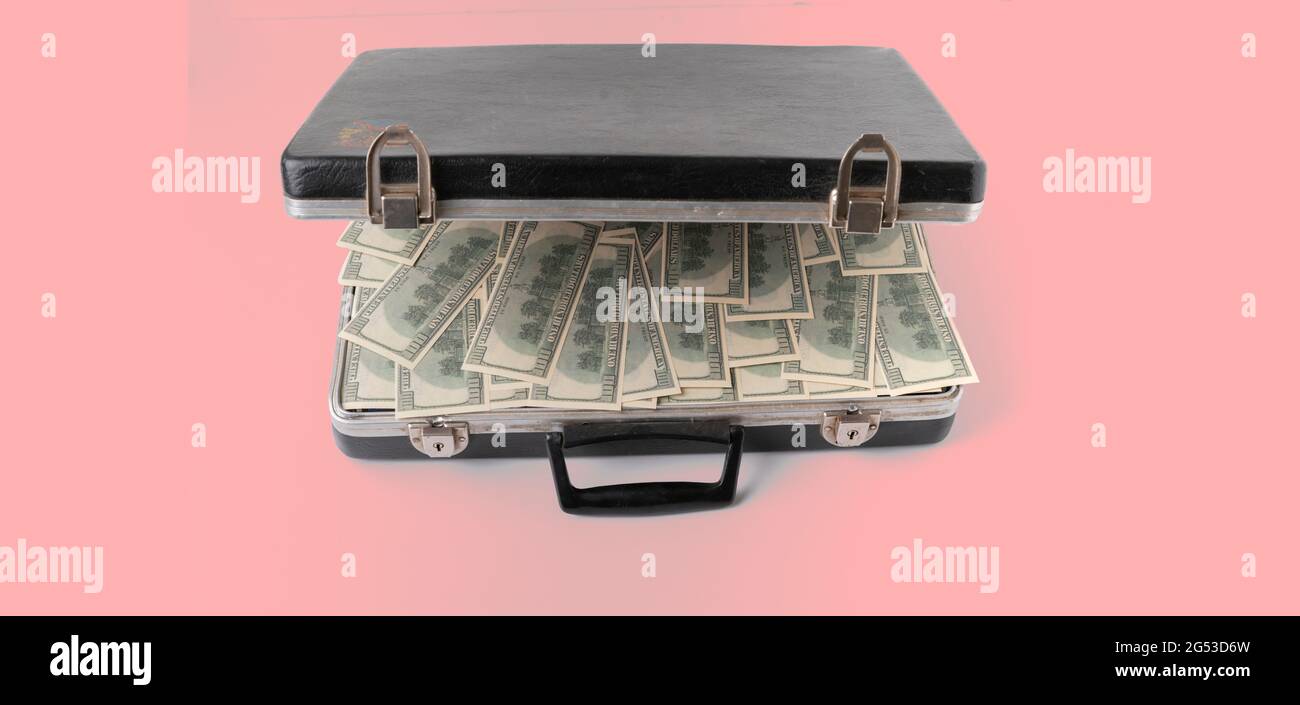 the opened vintage case full of cash dollar money, hundred banknote on ...