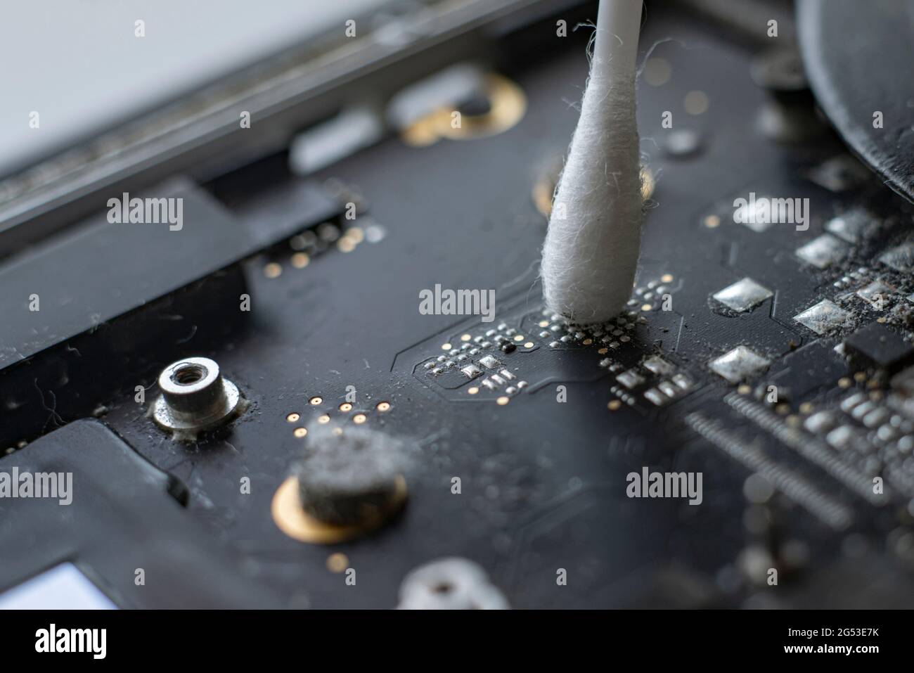macro view of removing dust from microprocessor board using the cotton ...