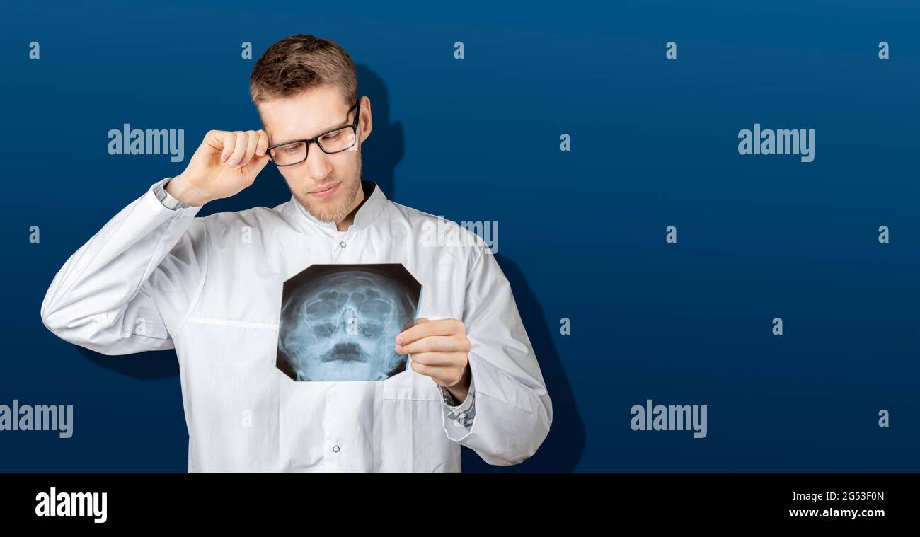 male doctor in medical unifrom in hospital holding the x-ray human scan ...