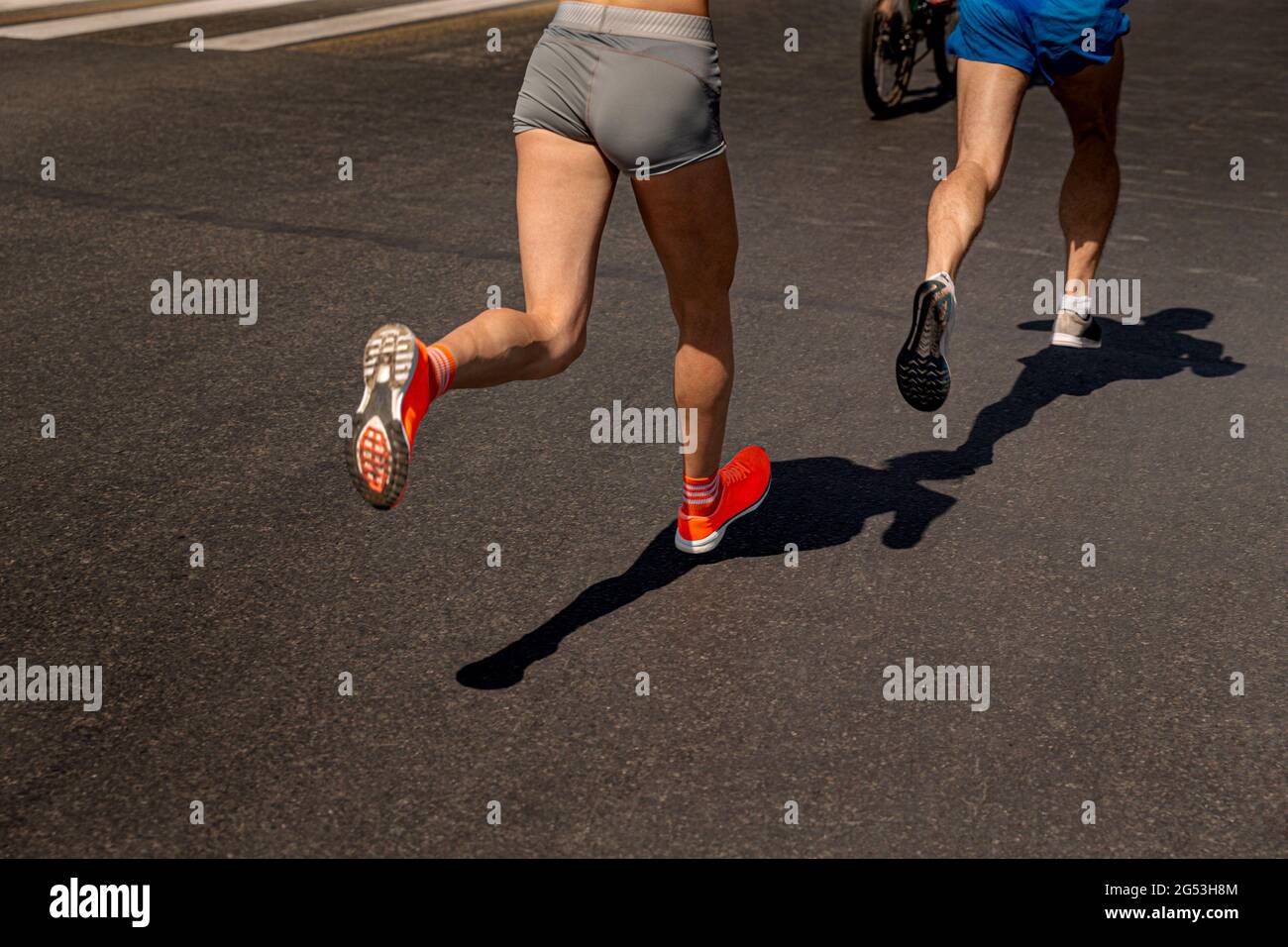 couple joggers athletes woman and man run in dark road Stock Photo - Alamy