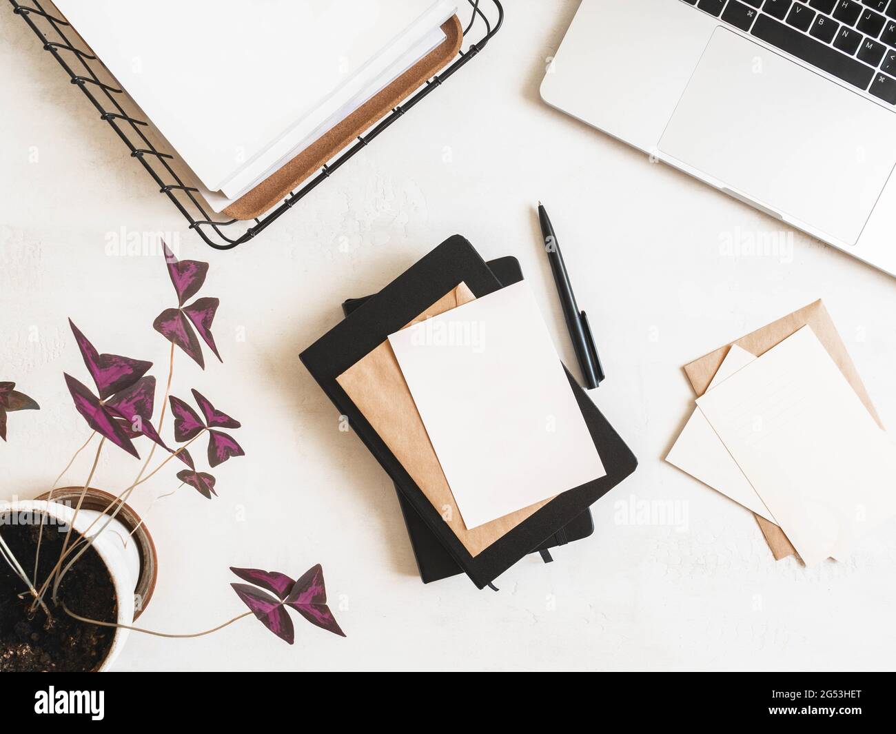 Home office desk with laptop, notebook, storage basket, purple ...
