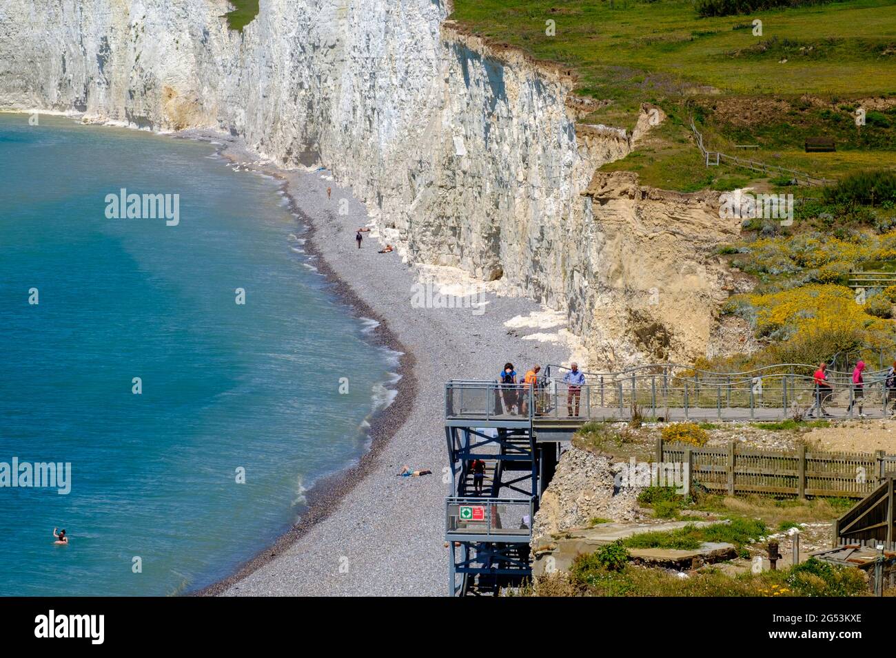 Staycation idea. People walk on the stairs to access Beachy Head Beach ...