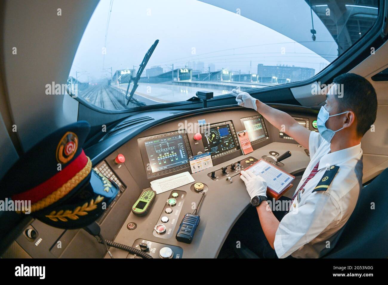 Chongqing, China. 25th June, 2021. A staff confirms signals on train ...