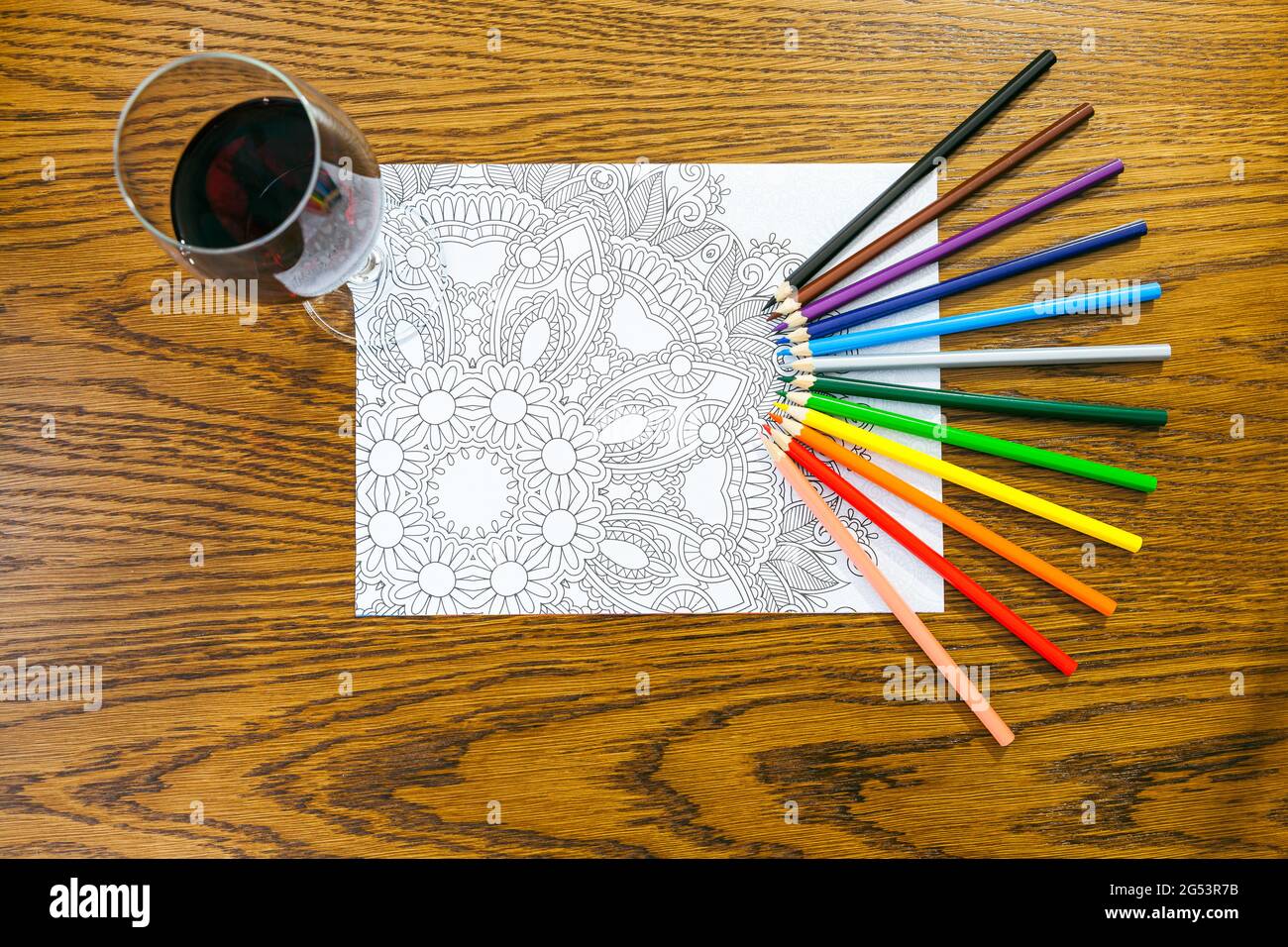 Adult coloring book and crayons on the table Stock Photo - Alamy