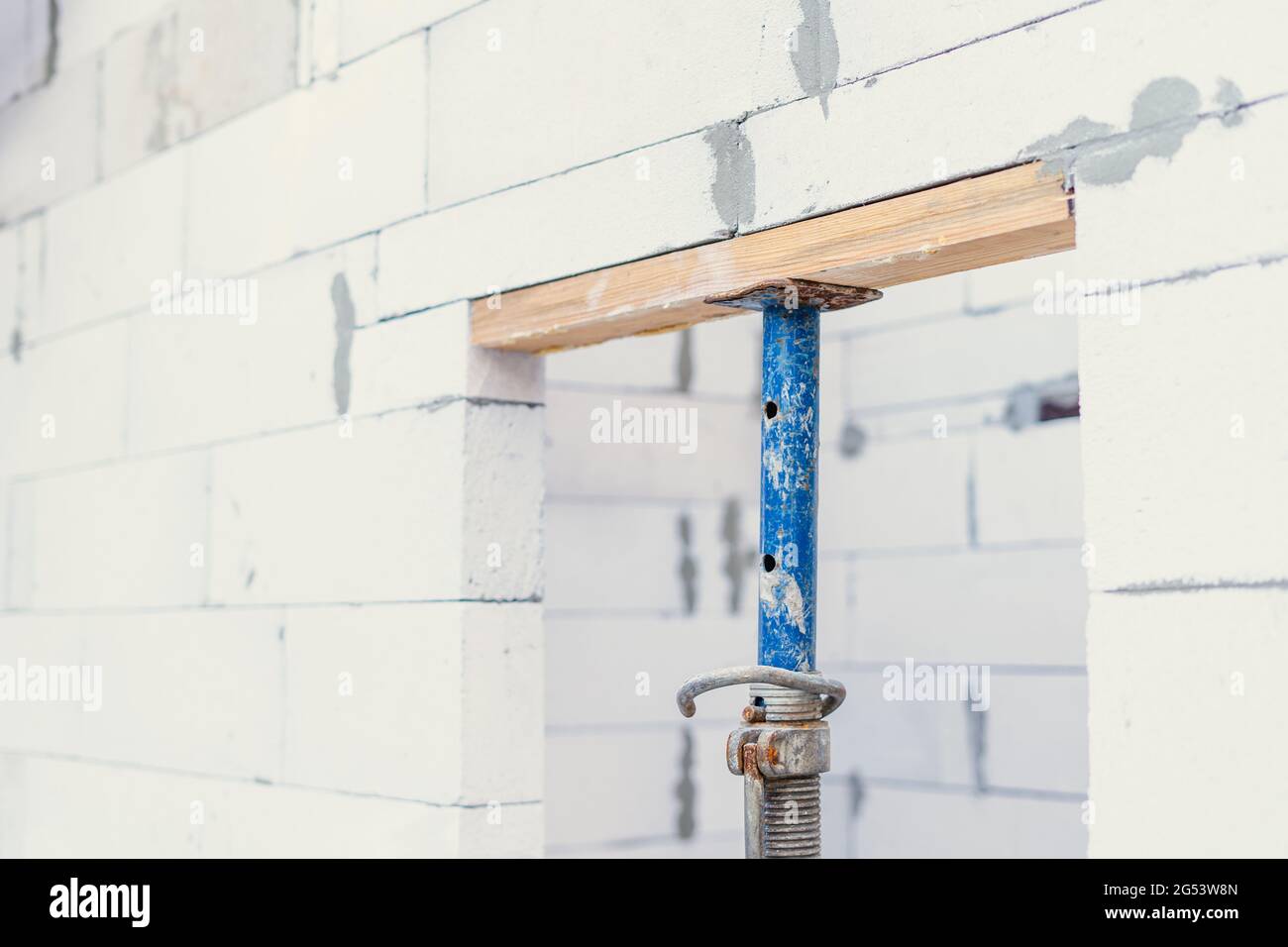 The construction strut supports the cinder block while it solidifies in ...