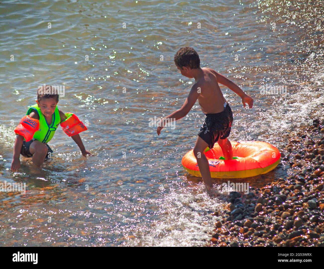 Children playing at the seaside in Brighton Stock Photo - Alamy