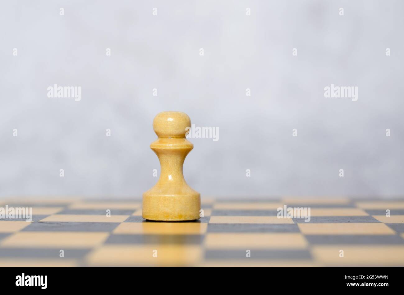 White wooden pawn on a chessboard. Chess pieces, side view Stock Photo ...