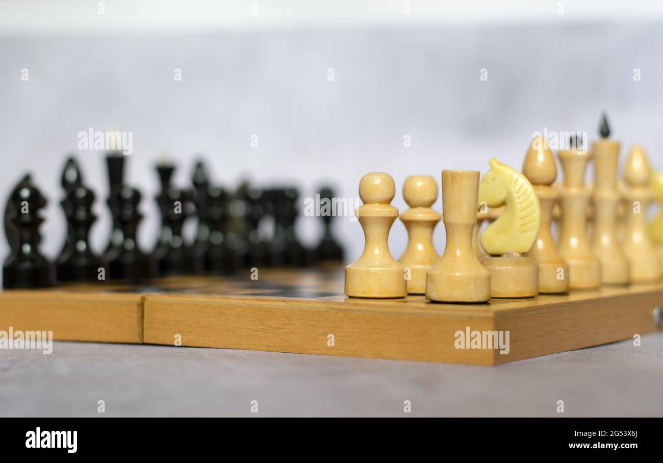Chess pieces on a chessboard side view, selective focus Stock Photo - Alamy