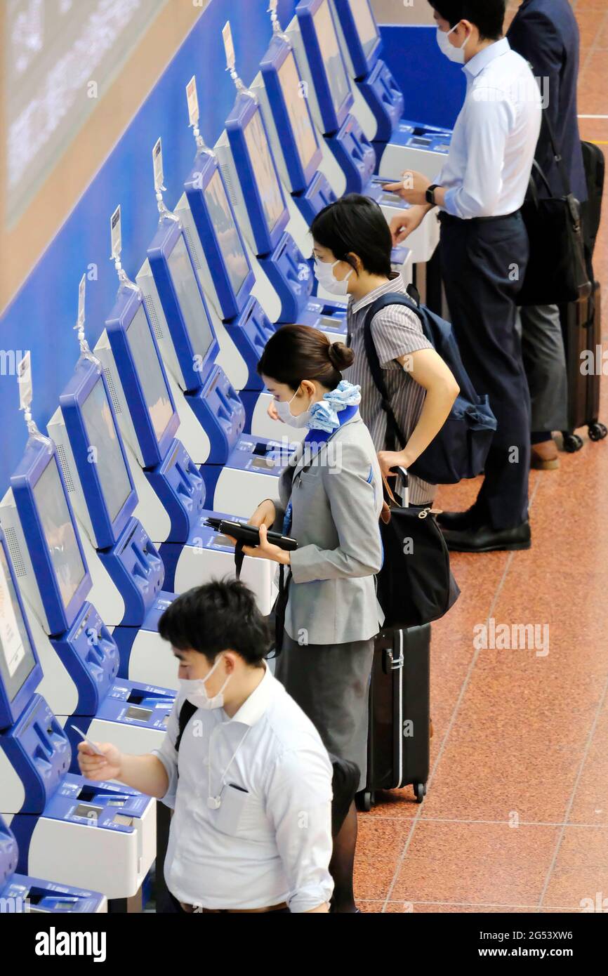 Tokyo, Japan. 24th June, 2021. Tourists check-in at Haneda Airport in ...