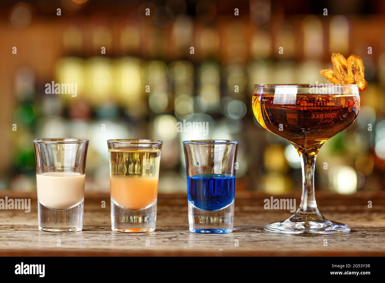 Assortment of cocktails in the bar. Cocktails stand in a row on the bar ...