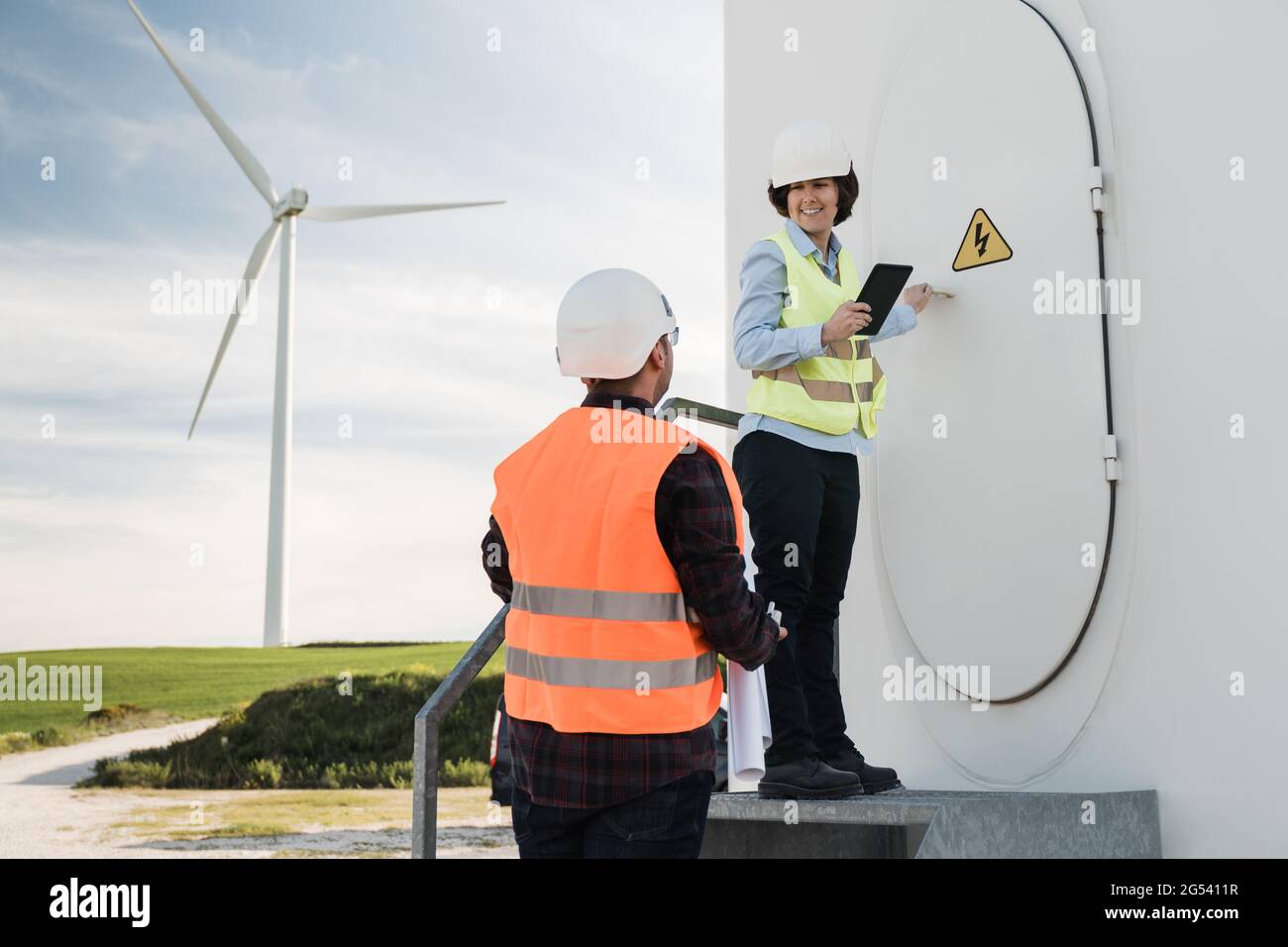Engineer people working at alternative energy wind green farm station ...