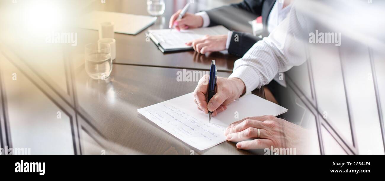 Business people taking notes during a training; multiple exposure Stock ...