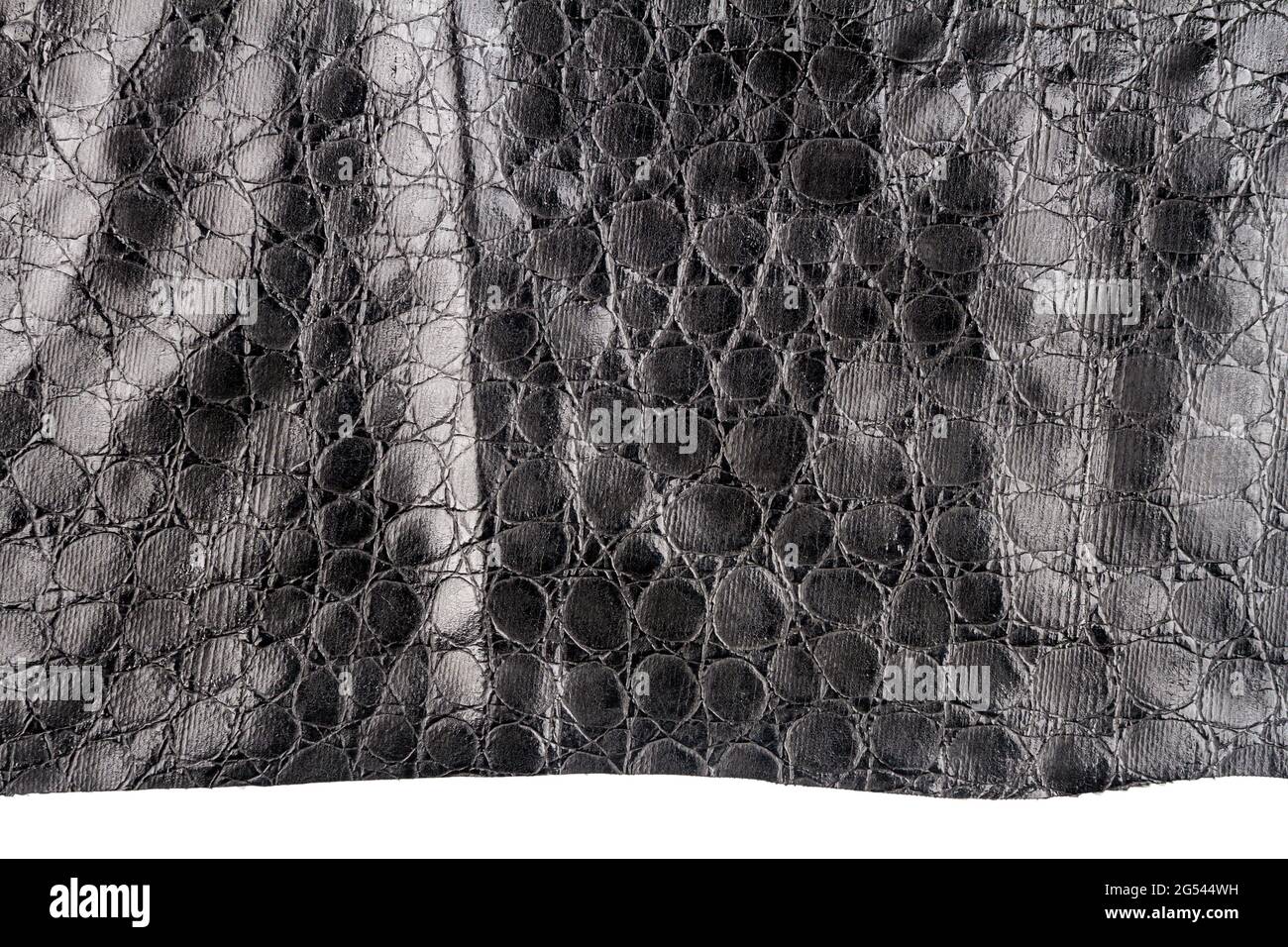 Piece of black artificial leather isolated on white background. Fake ...