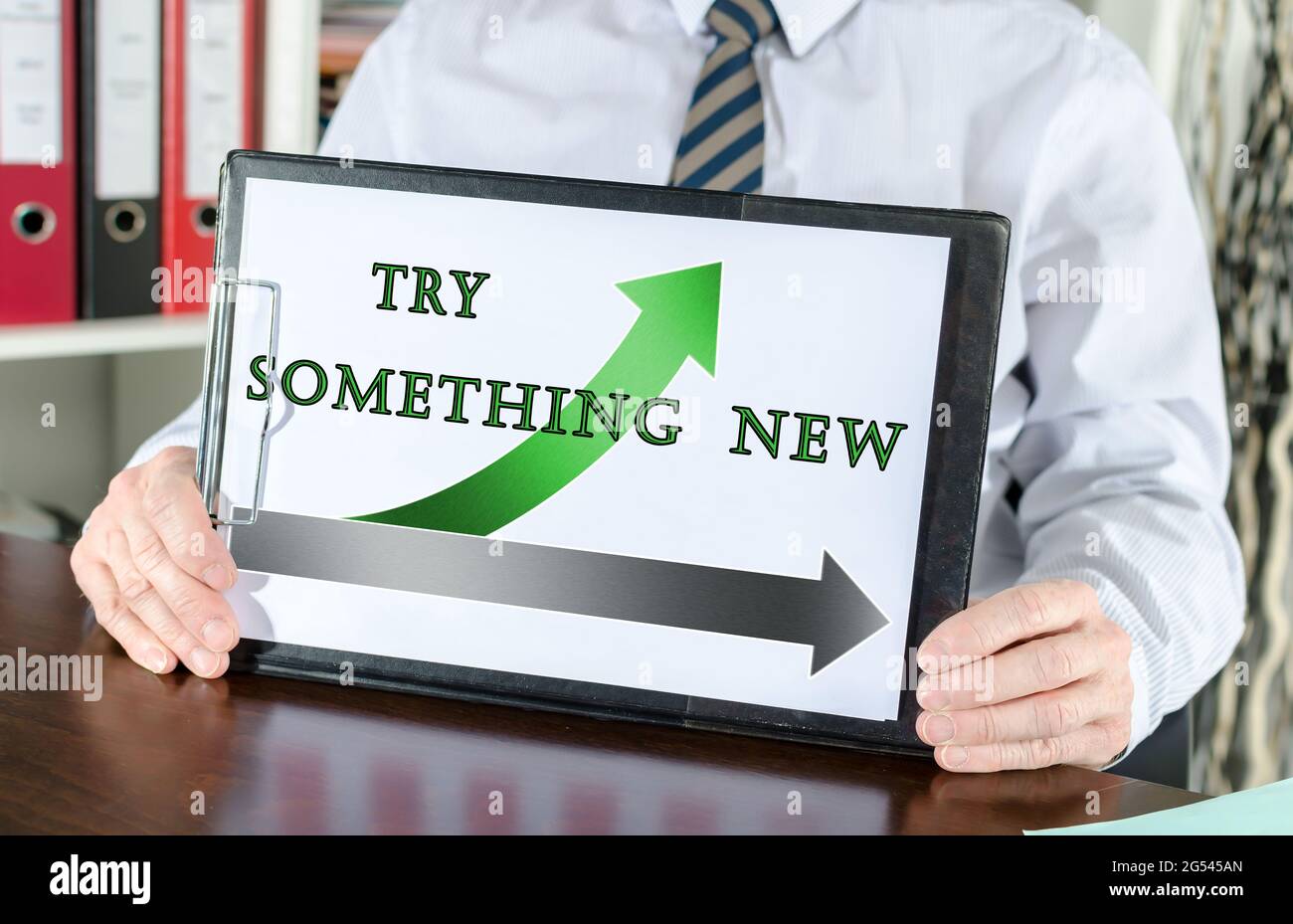 Try something new concept shown by a businessman Stock Photo - Alamy