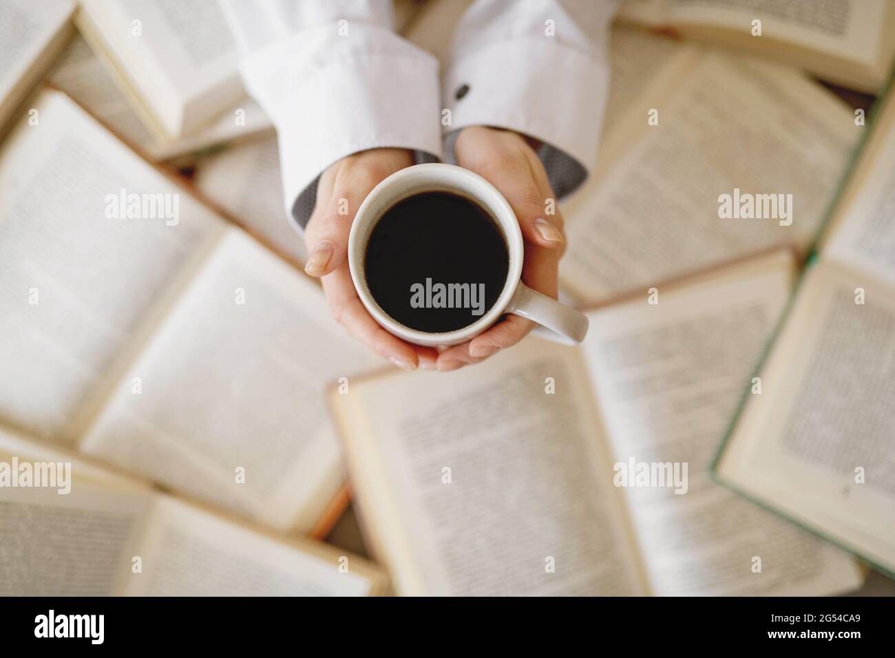 Human hand holding open book hi-res stock photography and images - Alamy