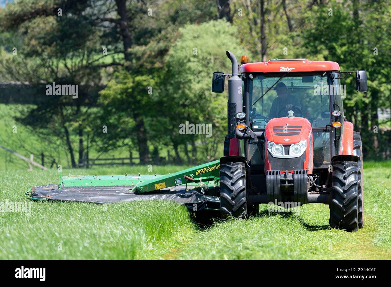 Mowing A Silage Meadow For First Cut Of Silage In Early June For A