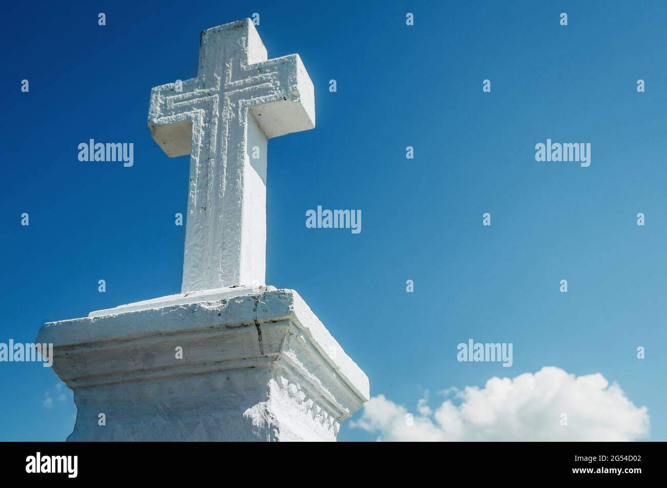Ancient white stone cross on background of blue sky Stock Photo - Alamy
