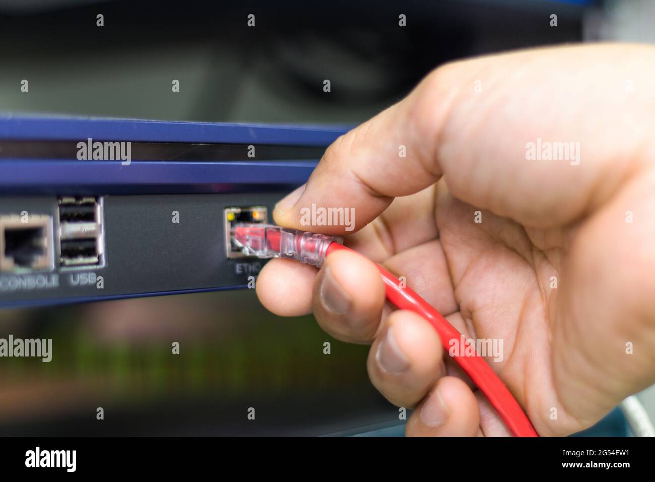 Hand of a man holding The network cables to connect the port of a ...