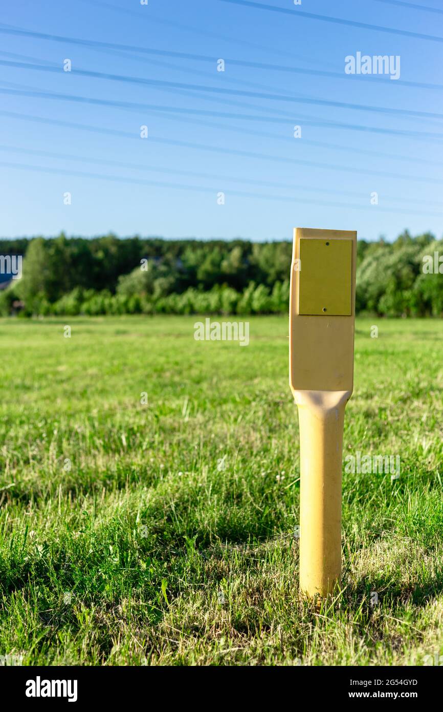 Yellow pillar with a sign - pointer. A warning Stock Photo - Alamy