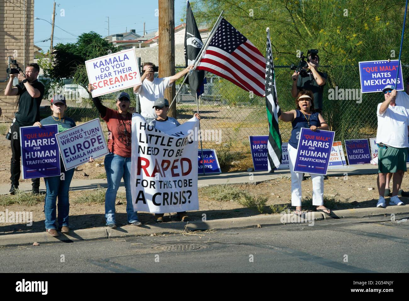 People protest on the side of the road as U.S. Vice President Kamala ...