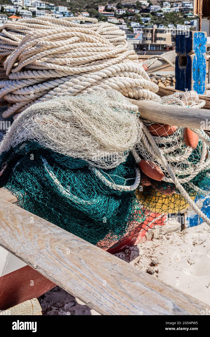 traditional fishing net and rope on small rowing boat on beach Stock ...