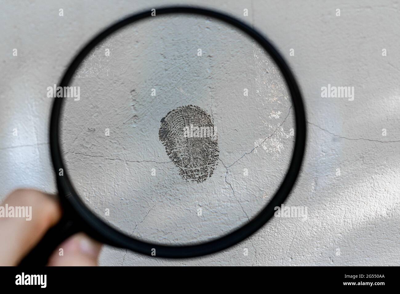 a crime investigation, a magnifying glass and the fingerprint on the ...