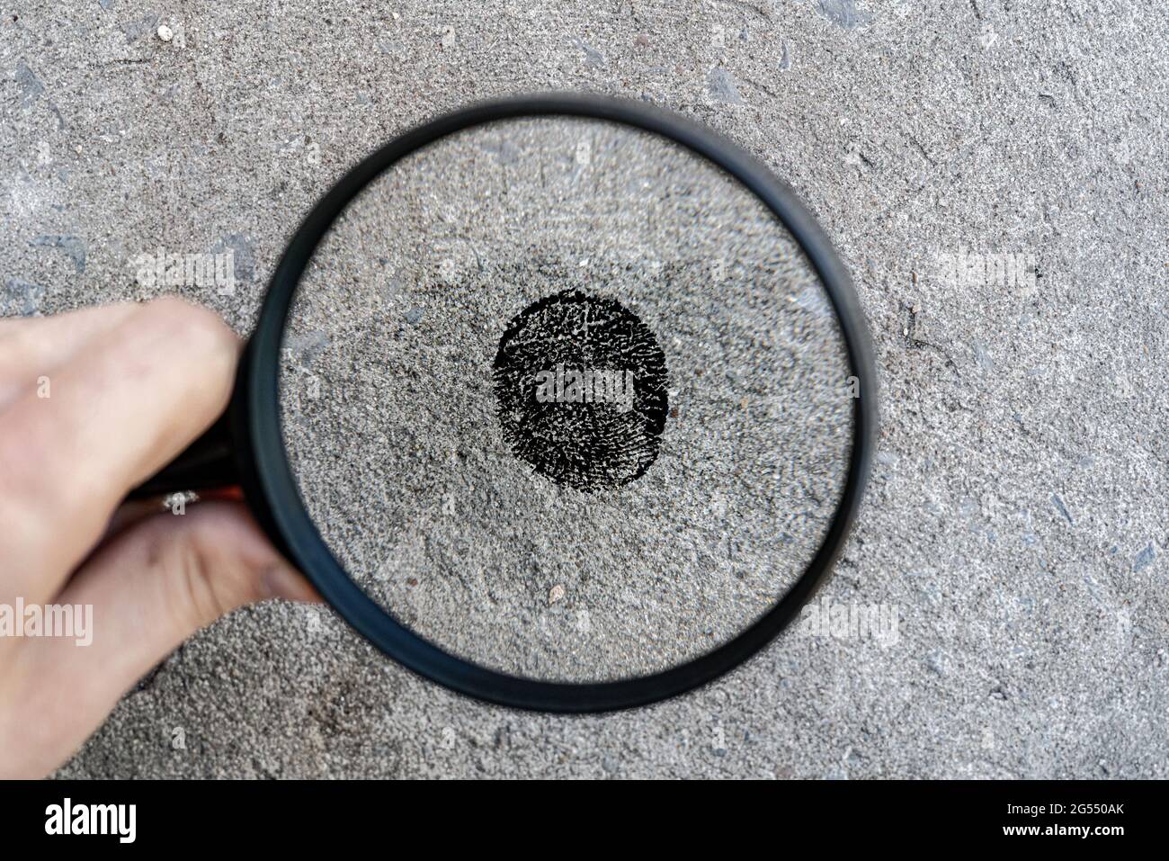 a crime investigation, a magnifying glass and the fingerprint on the ...