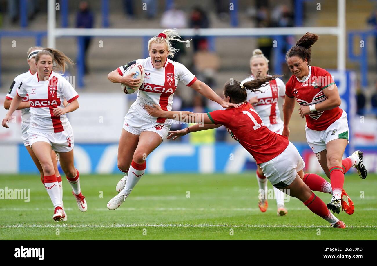 England's Amy Hardcastle (centre) gets tackled by Wales' Emily Hughes ...