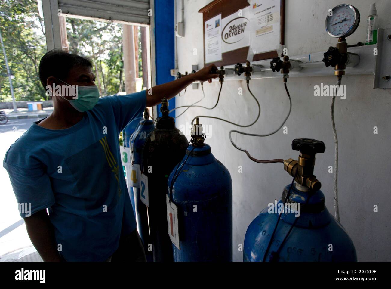 A worker refills oxygen cylinder for hospitals as the demand for ...