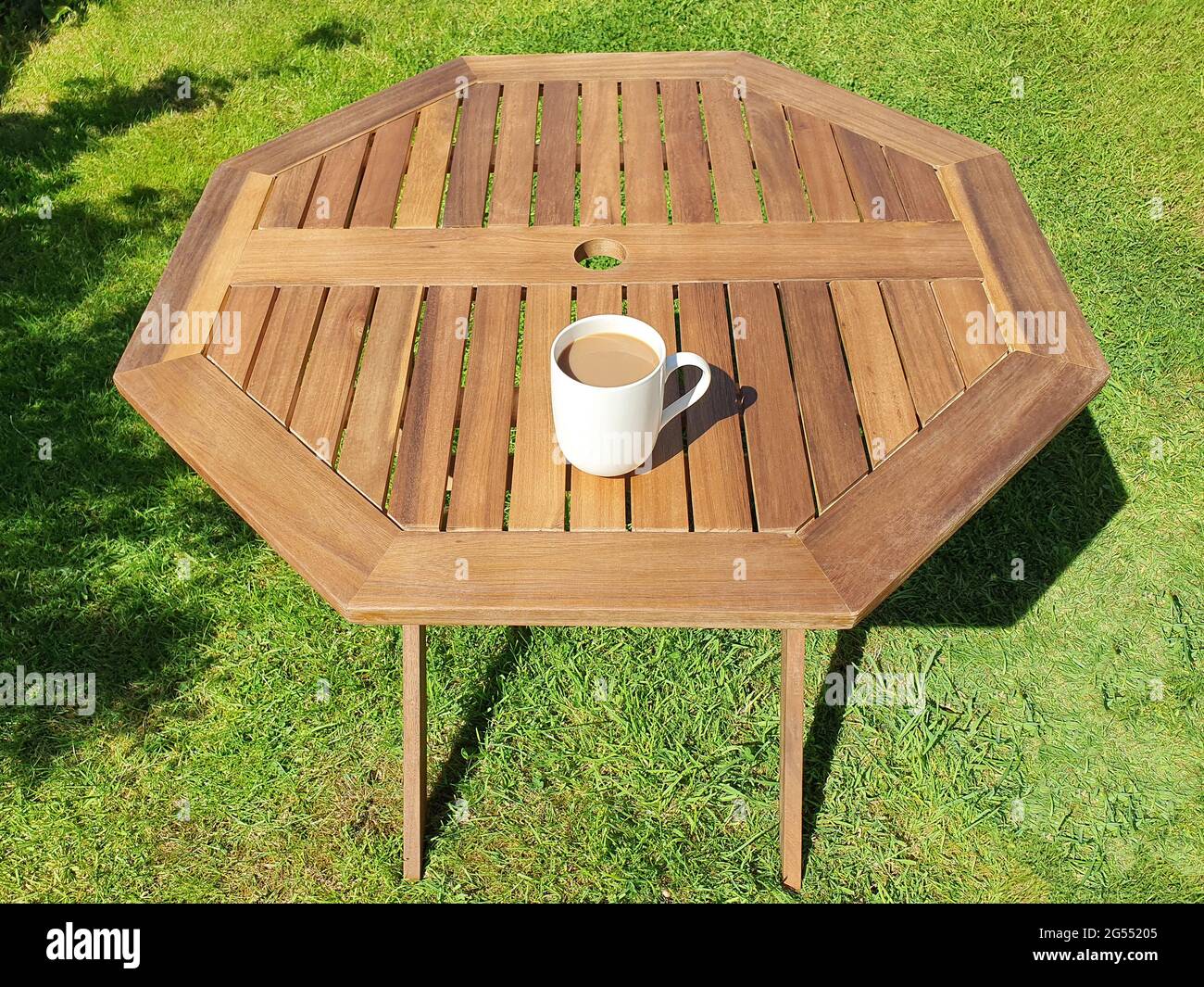 Wooden foldable acacia garden picnic table with a mug of tea suggesting ...