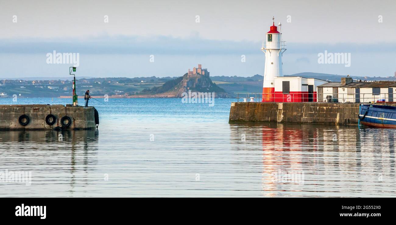 Newlyn Harbour and the picturesque lighthouse on the south pier wall ...