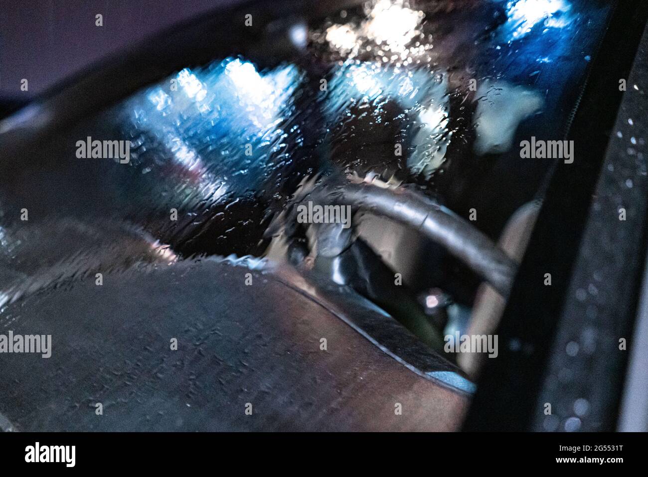 glass material texture covered with water raindrops in the car during ...