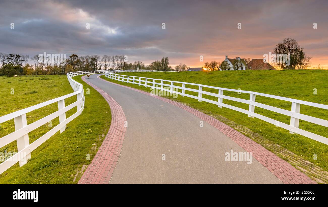 Dutch Countryside landscape with historical houses in evening along a ...