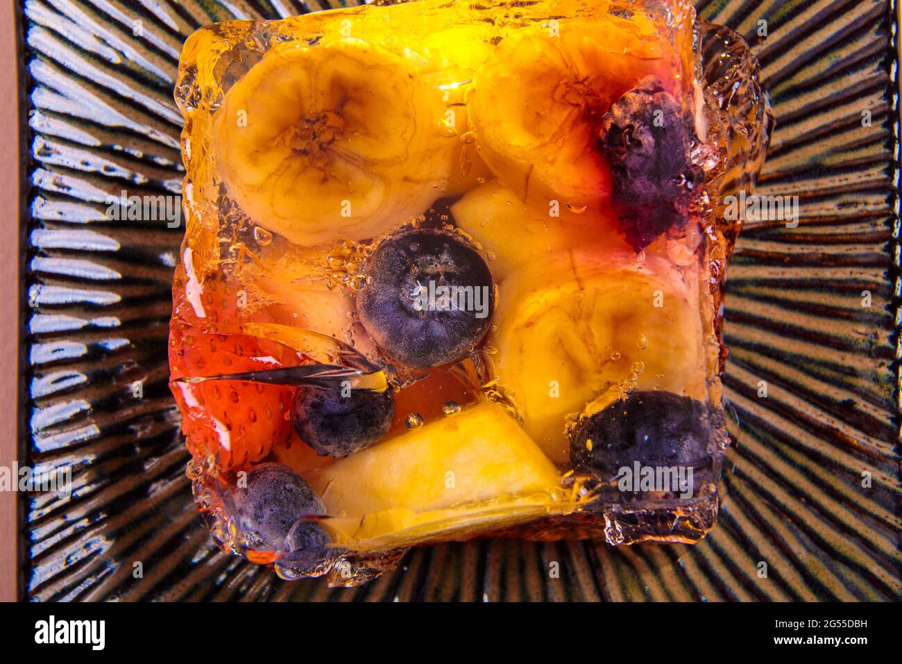 Jelly from different fruits and berries on a square saucer. Dessert ...