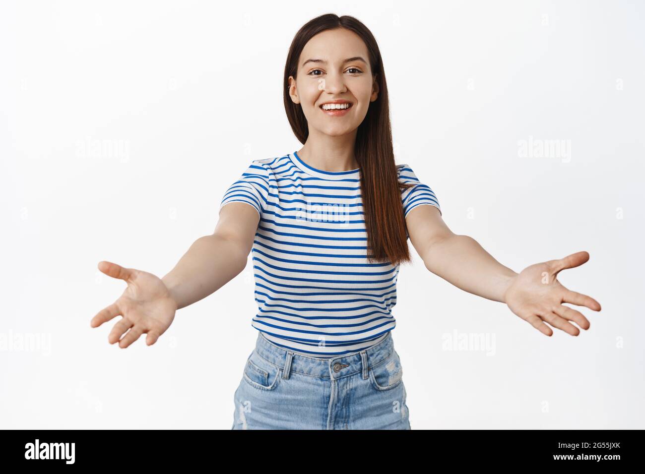 Come here. Smiling friendly 20s girl spread her arms for hug, warm ...