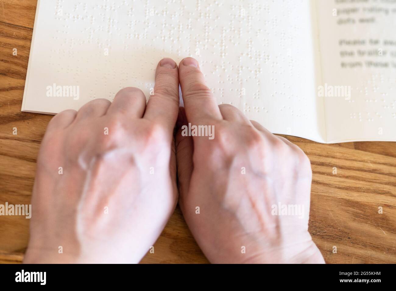 point-of-view female fingers reading book with braille closeup on ...