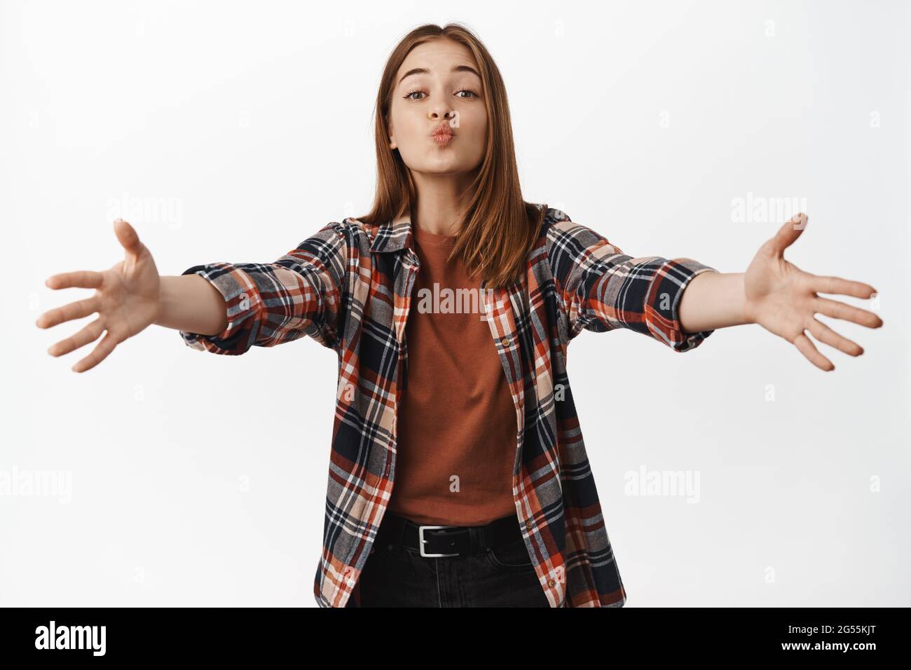 Silly and cute girlfriend reaching for kiss and hugs, stretching out ...