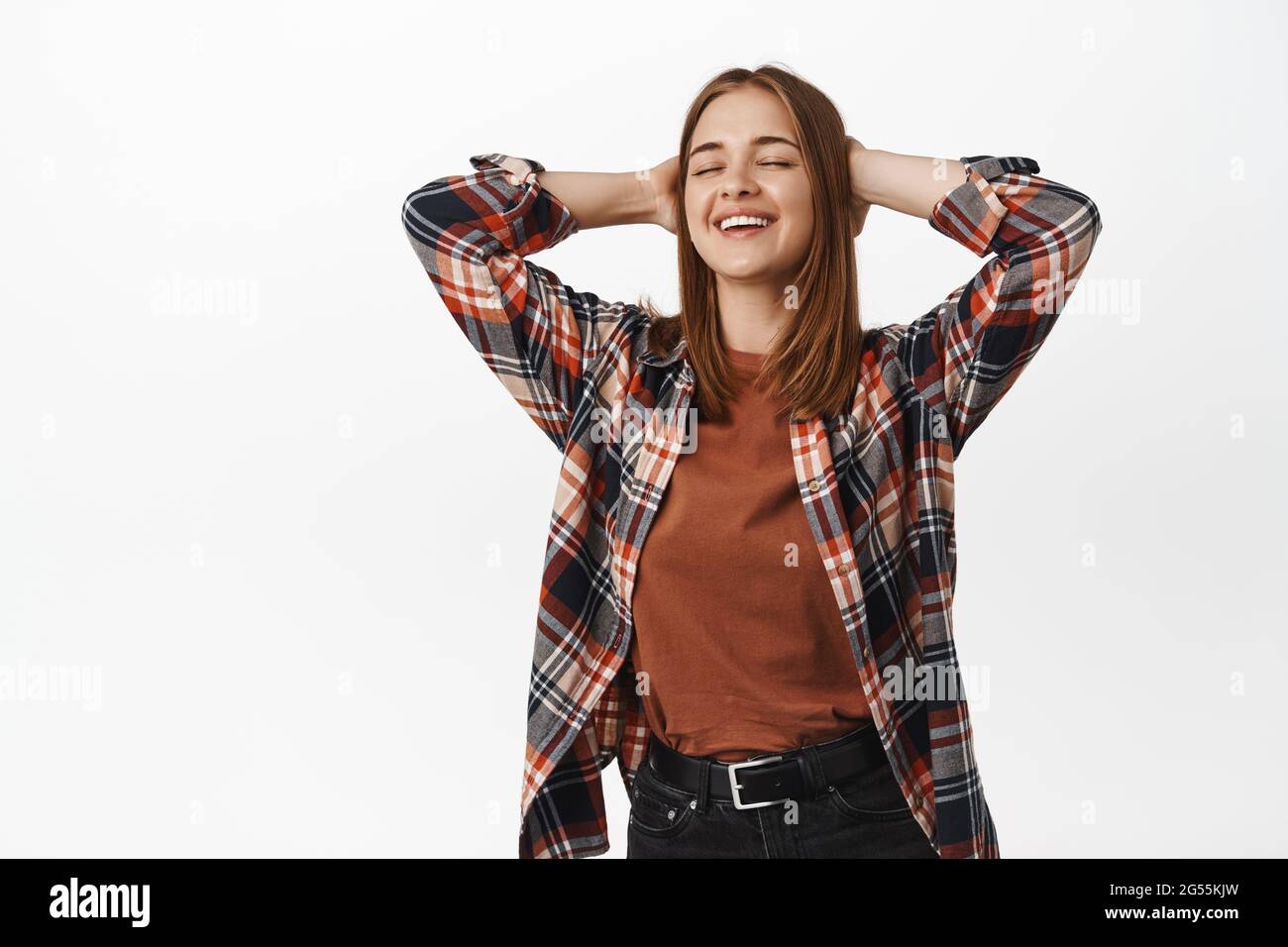 Finally free time. Smiling satisfied young woman resting, having break ...