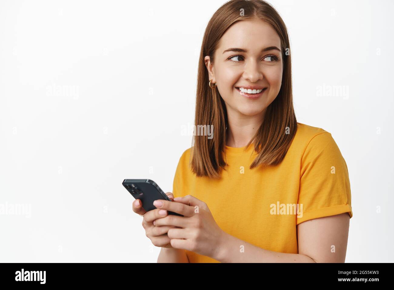 Smiling young woman use smartphone, hold cell phone mobile app, turn ...