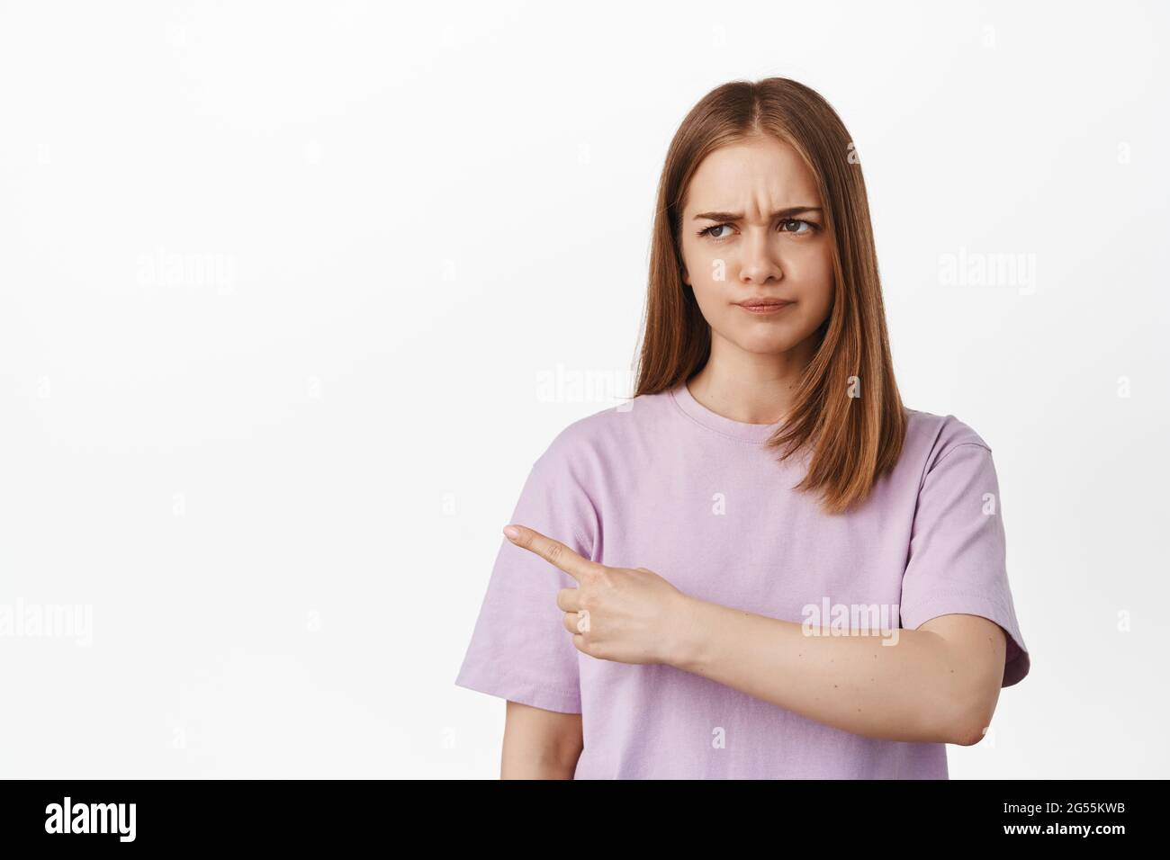 That it bad. Displeased blond woman pointing, furrow eyebrows with ...