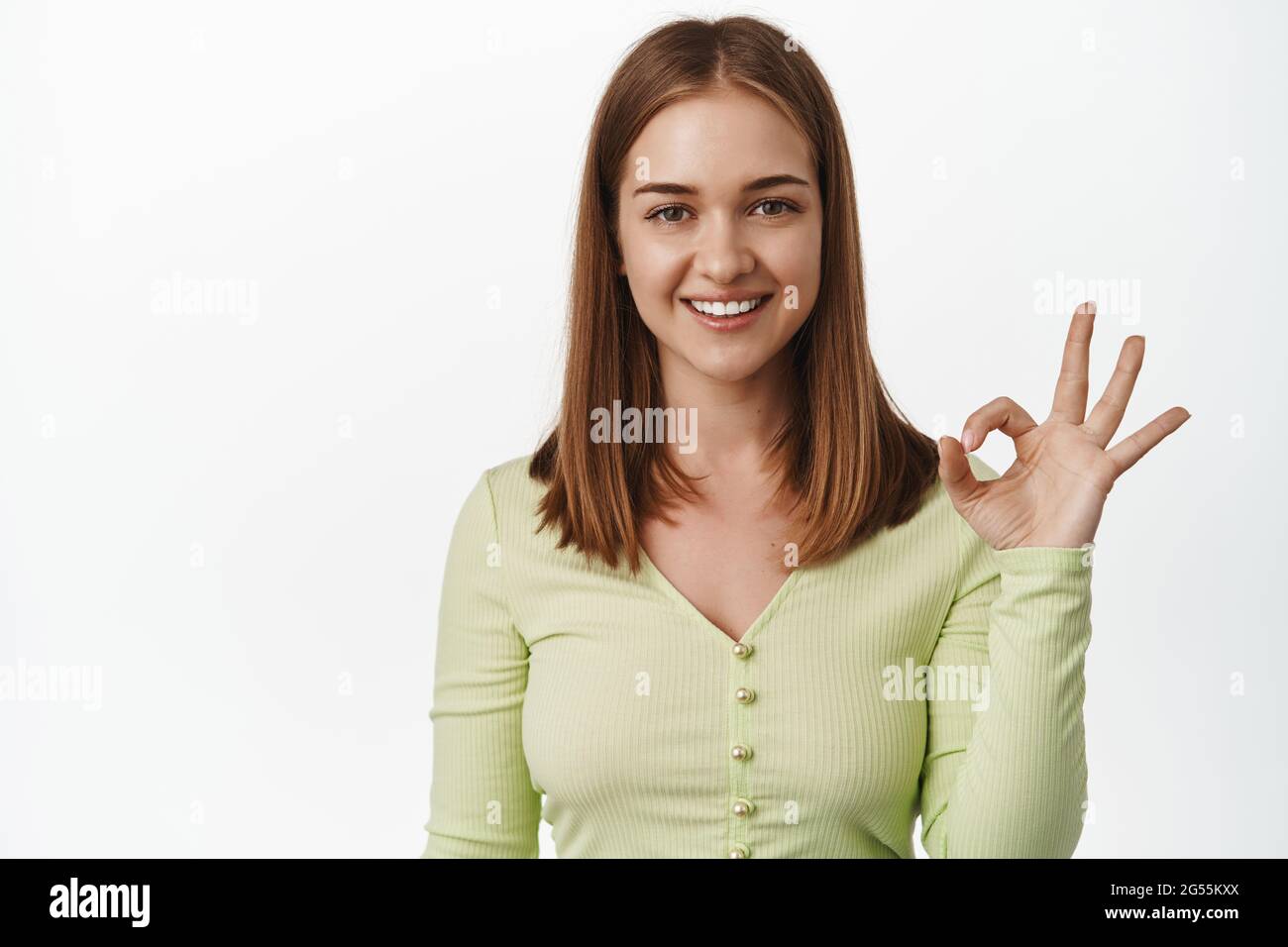 Okay. Smiling blond girl shows ok zero gesture, no problem, yes or ...