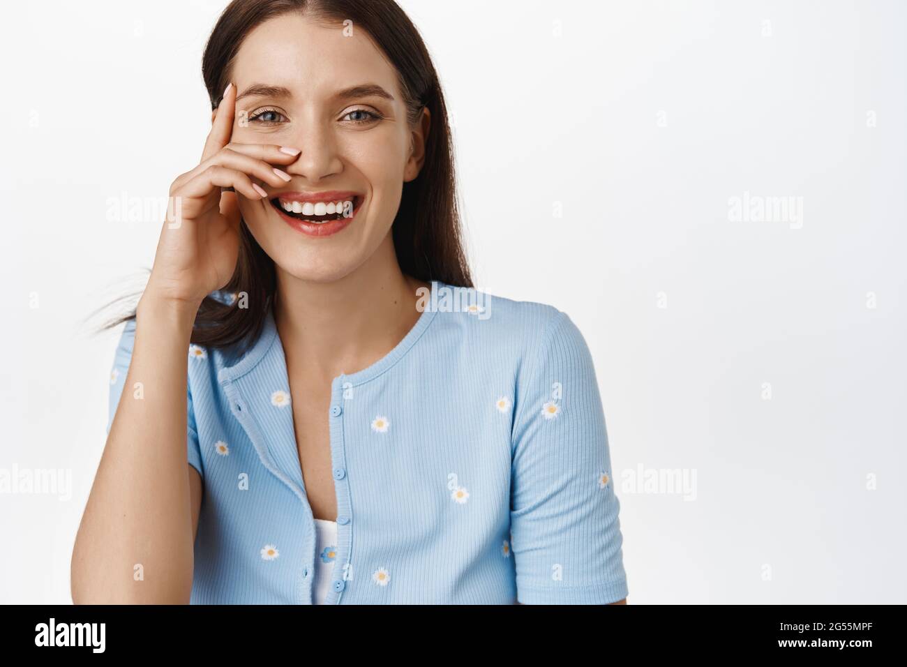 Portrait of tender, beautiful woman, touching natural facial skin with ...