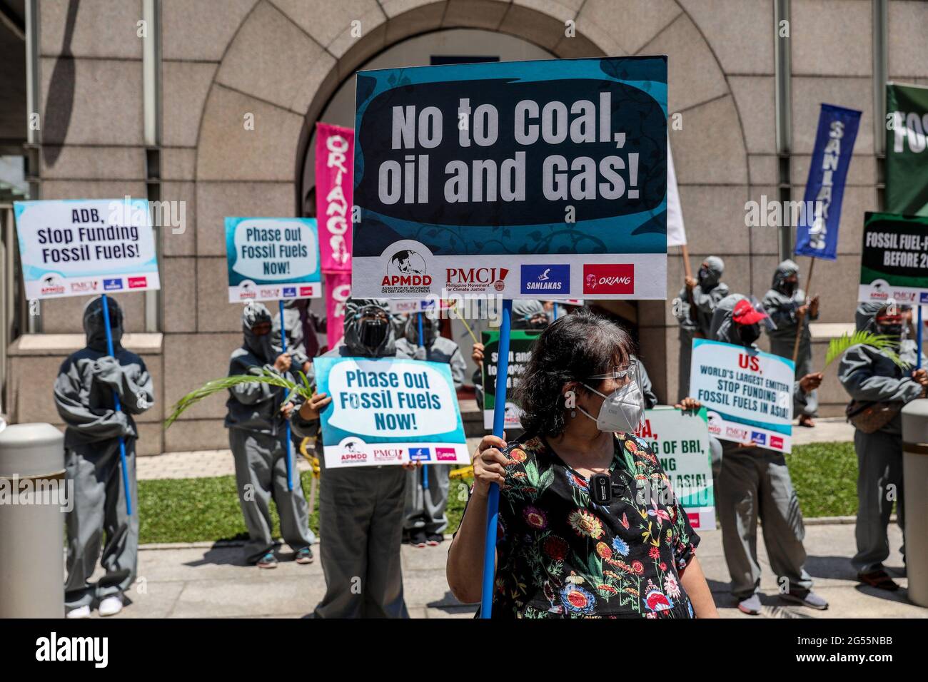 Climate activists dressed in costumes carry signs as they protest ...