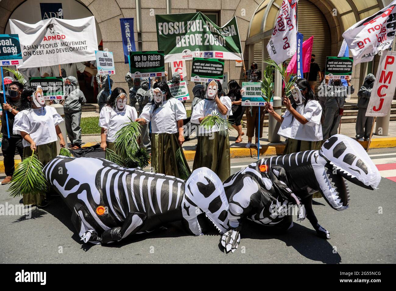 Climate activists dressed in costumes and dinosaur fossils perform ...