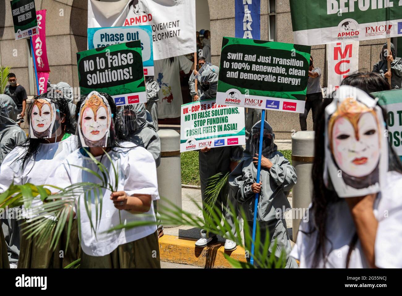 Climate activists dressed in costumes carry signs as they protest ...