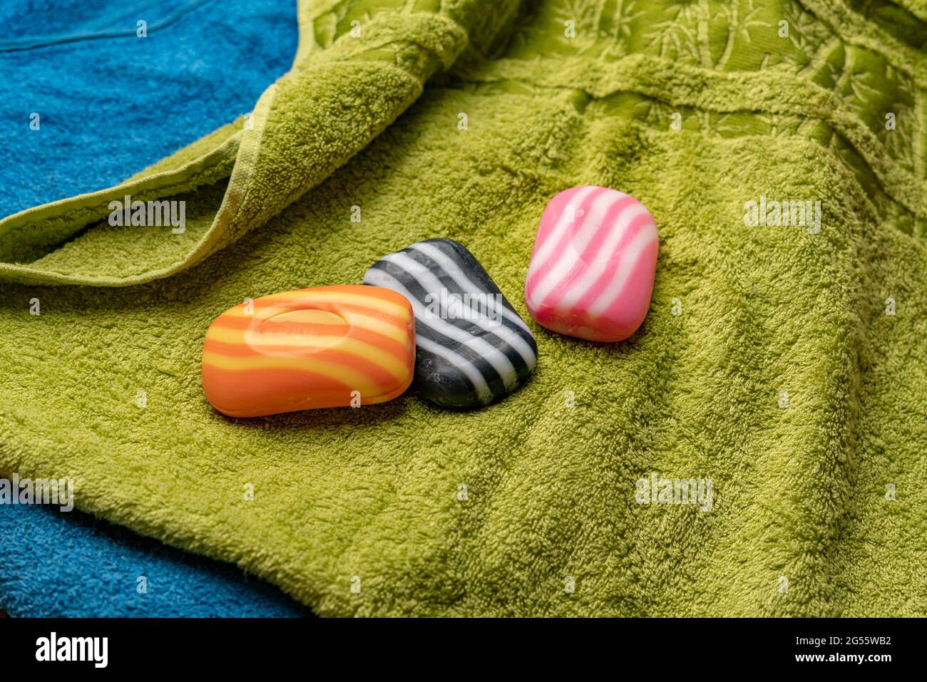 three pieces of striped soap bars on the towel textile texture, spa and ...