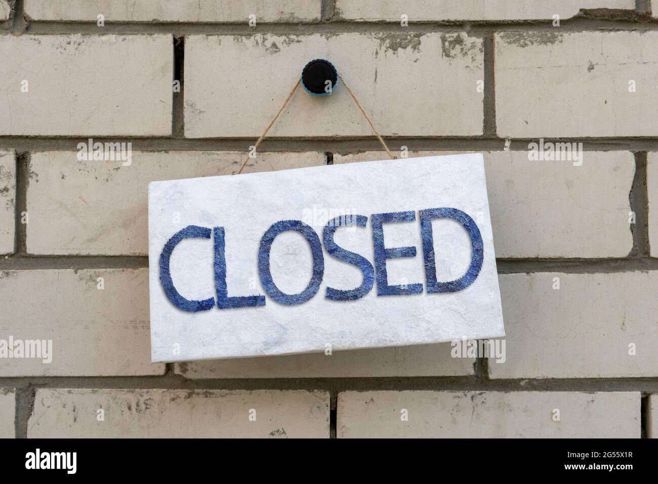 the simple sign board frame hanging on the wall of the building ...