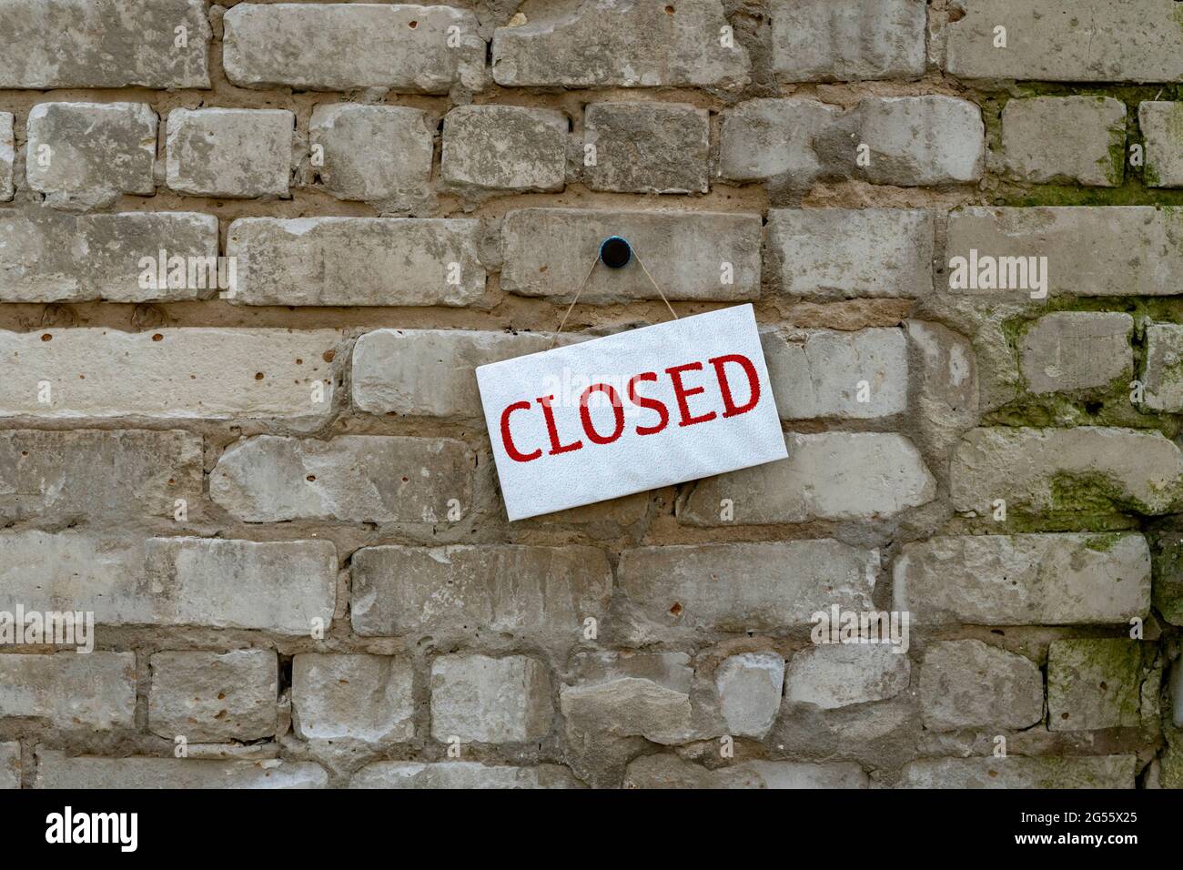 the simple sign board frame hanging on the wall of the building ...
