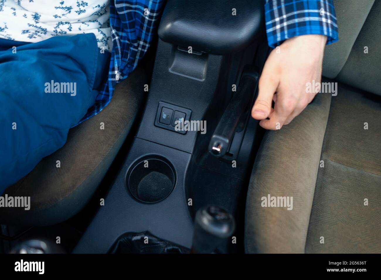 close up cropped hand using the handbrake, driver sitting inside the ...